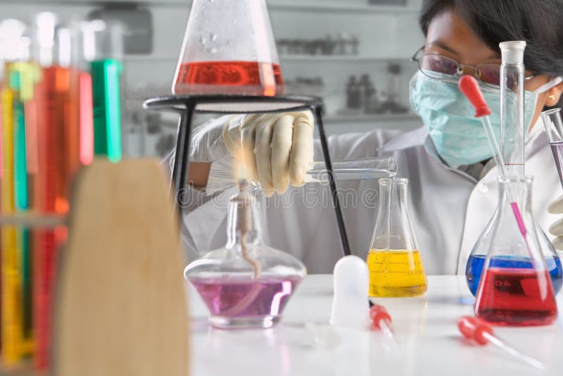 Scientist doing experiment stock image. Image of mask - 14476153