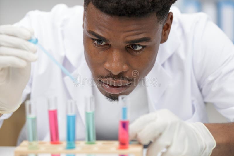 Scientist Dripping Reagent into Test Tubes Stock Photo - Image of ...