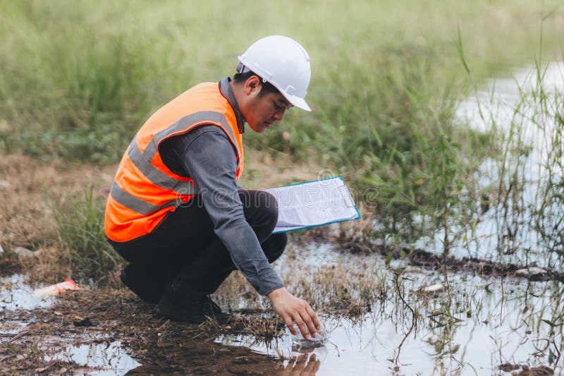 Scientist Ecologist Taking a Water Sample and Reading Ph Value at River ...