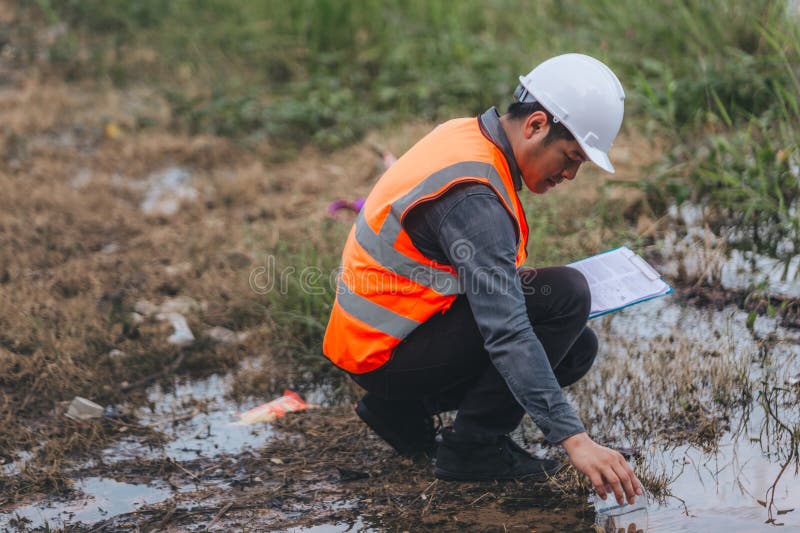 Scientist Ecologist Taking a Water Sample and Reading Ph Value at River ...