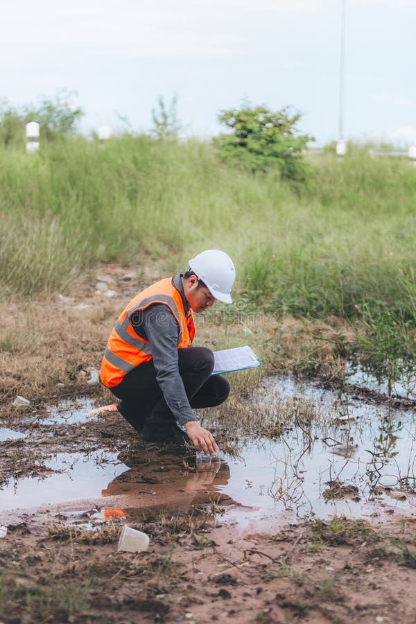 Scientist Ecologist Taking a Water Sample and Reading Ph Value at River ...