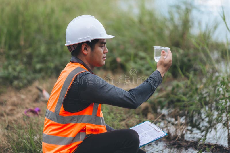 Scientist Ecologist Taking a Water Sample and Reading Ph Value at River ...