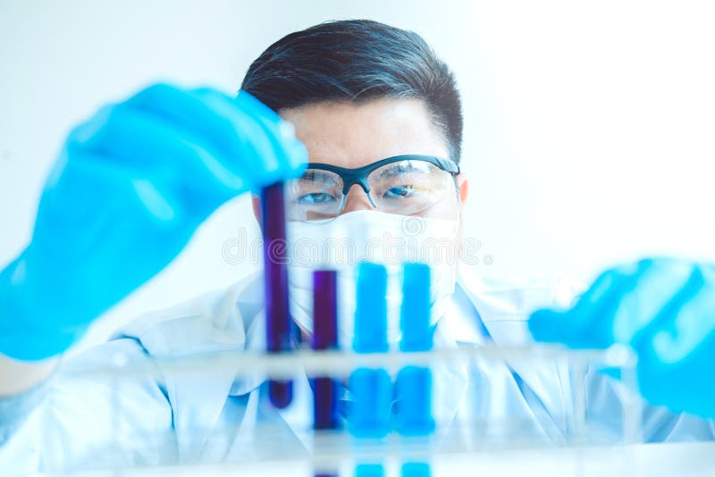 Scientist with Equipment Holding Tools during Scientific Experiment ...
