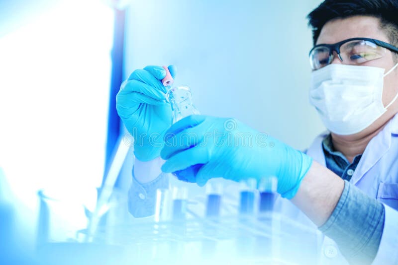 Scientist with Equipment Holding Tools during Scientific Experiment ...