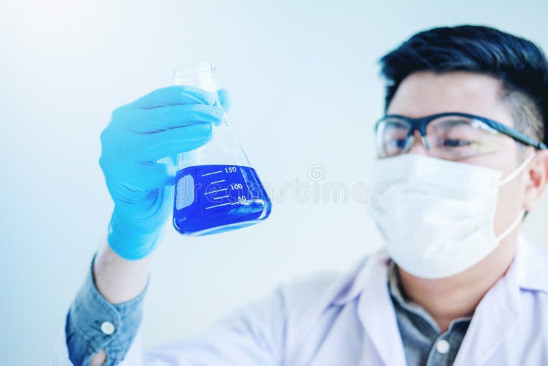 Scientist with Equipment Holding Tools during Scientific Experiment ...