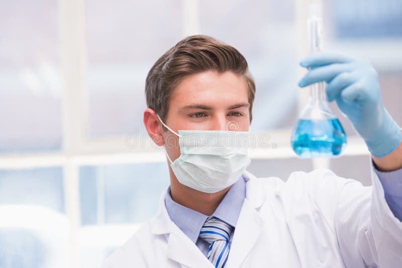 Scientist Examining Beaker with Blue Fluid Stock Image - Image of male ...