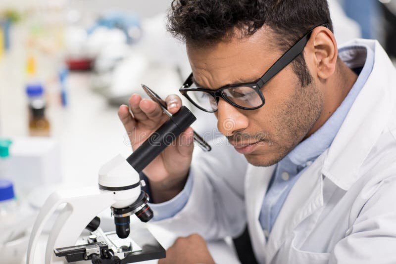 Scientist in Eyeglasses Working with Microscope in Research Laboratory ...