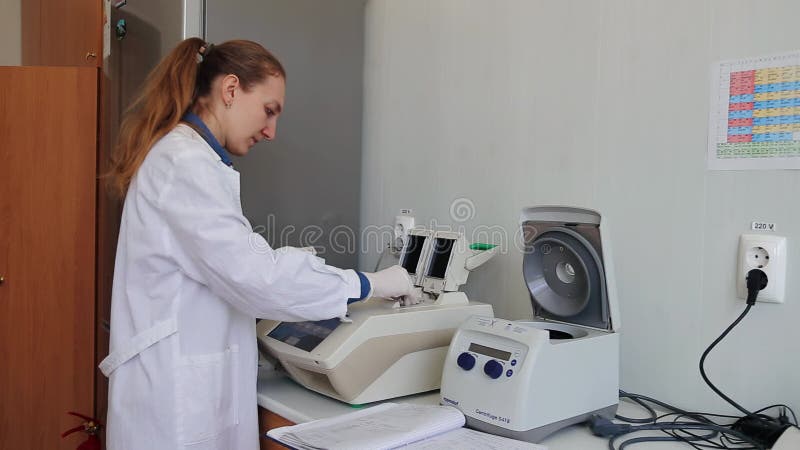 Scientist with Gloved Hand Putting DNA Sample into Real-time PCR-cycler ...