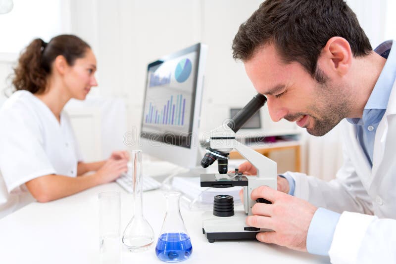 Scientist and Her Assistant in a Laboratory Stock Image - Image of ...