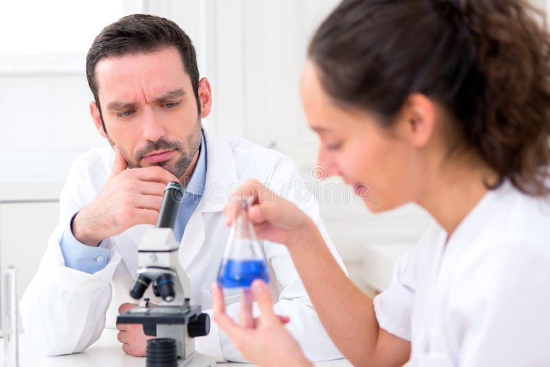 Scientist and Her Assistant in a Laboratory Stock Photo - Image of ...