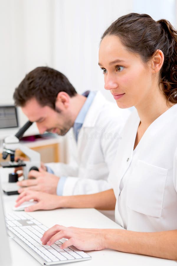 Scientist and Her Assistant in a Laboratory Stock Photo - Image of ...