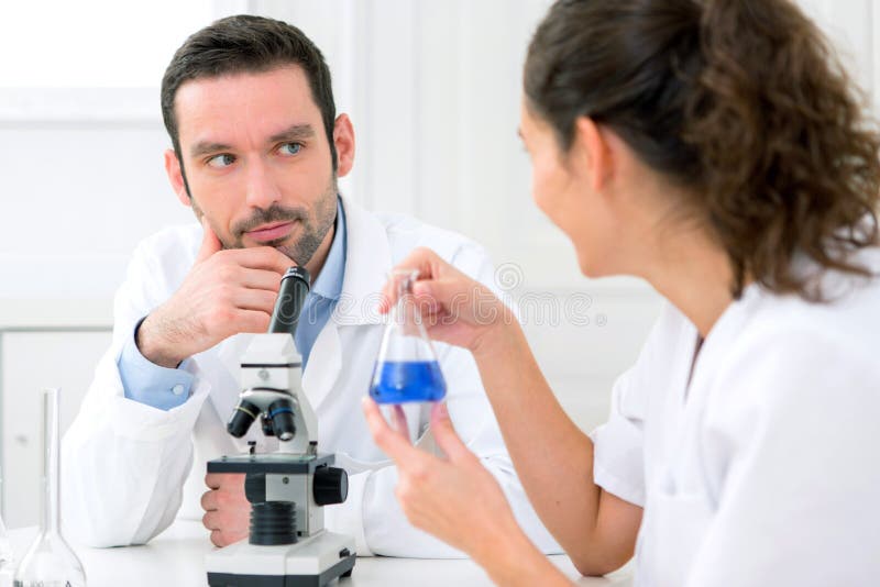 Scientist and Her Assistant in a Laboratory Stock Image - Image of ...