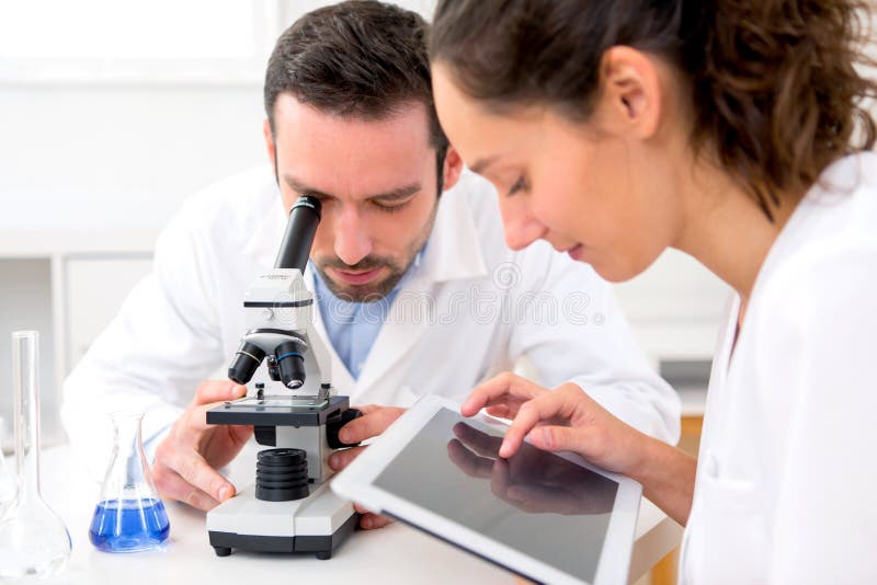 Scientist and Her Assistant in a Laboratory Stock Image - Image of ...