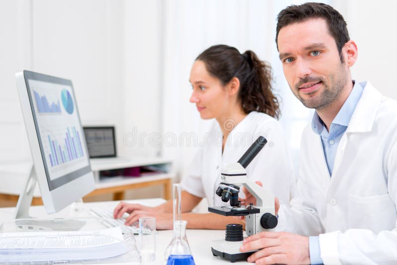 Scientist and Her Assistant in a Laboratory Stock Photo - Image of ...