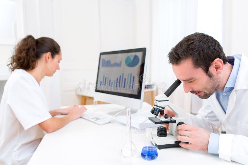 Scientist and Her Assistant in a Laboratory Stock Photo - Image of ...