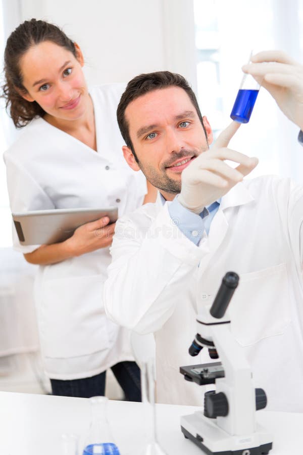 Scientist and His Assistant Working in a Lab Stock Image - Image of ...