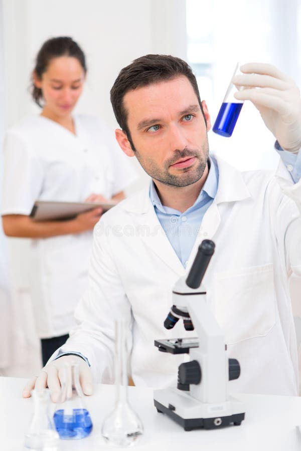 Scientist and His Assistant Working in a Lab Stock Photo - Image of ...