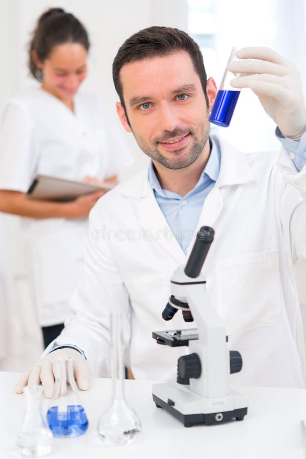 Scientist and His Assistant Working in a Lab Stock Image - Image of ...