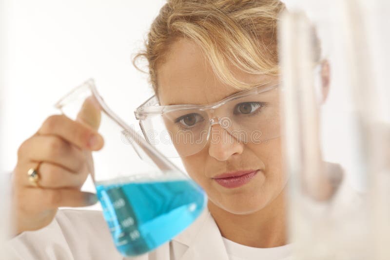 Scientist holding beaker stock image. Image of science - 17241465