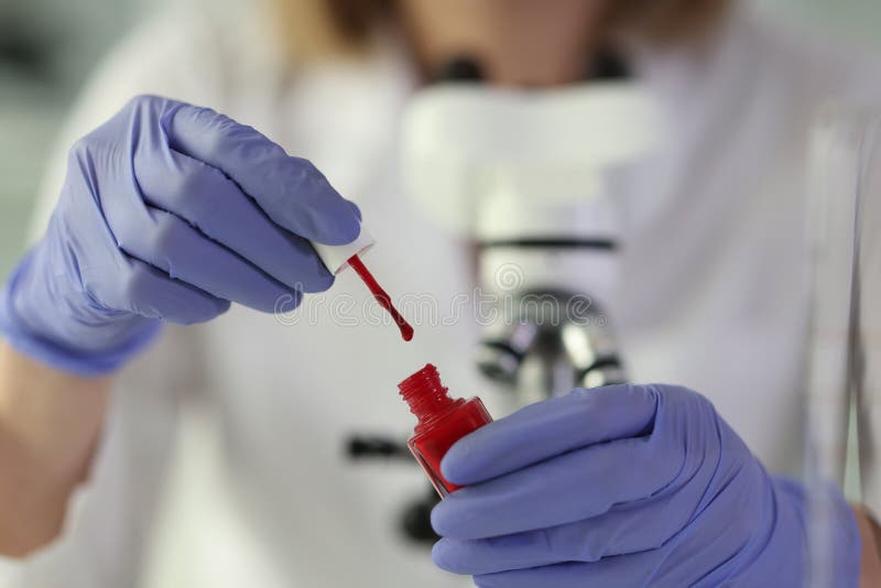 Scientist Holding Bottle with Red Paint and Doing Tests in Laboratory ...