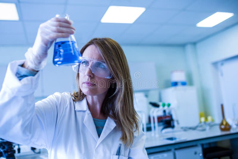 Scientist Holding Up Beaker of Chemical Stock Image - Image of ...