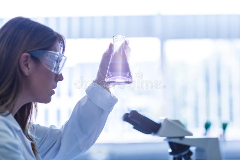 Scientist Holding Up Beaker of Chemical Stock Image - Image of ...