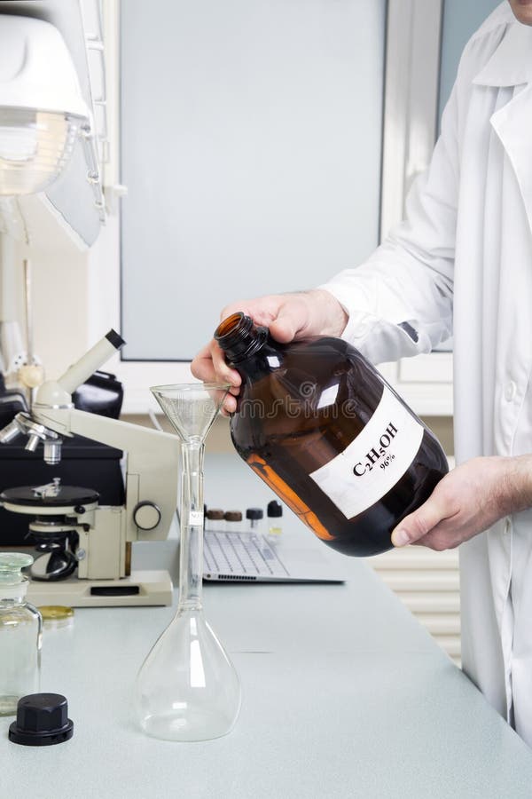 Scientist Holds Bottle in Laboratory Interior. Stock Photo - Image of ...