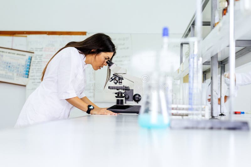 Scientist in Lab Coat Examining Microscope in Laboratory Stock Image ...