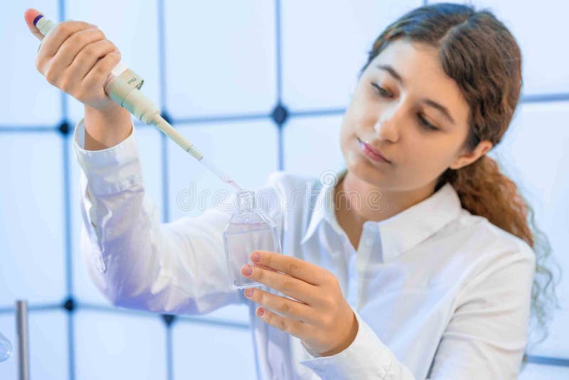 Scientist in Lab Coat Performs Scientific Experiment in Laboratory ...