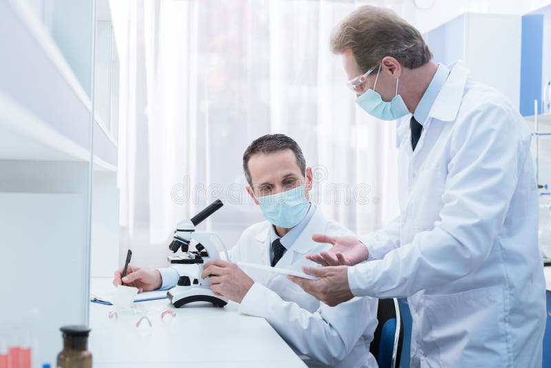 Scientists Talking while Working in Lab Stock Photo - Image of team ...