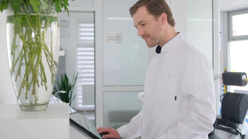 A Scientist in a Lab Coat is Using a Tablet Computer Stock Video ...