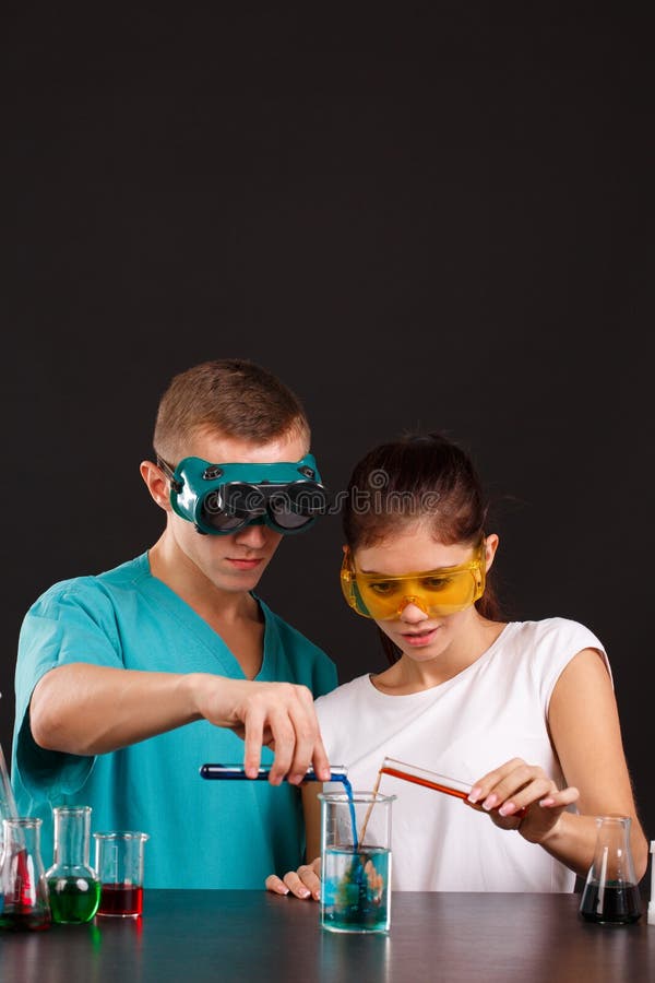 Scientist with a Lab Assistant Mix Reagents on a Black Background Stock ...