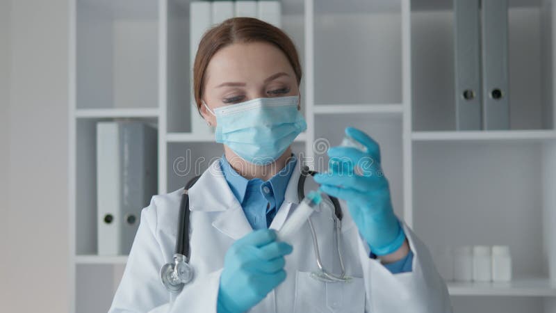 A Scientist in the Laboratory Examines the Microcosm Under a Microscope ...