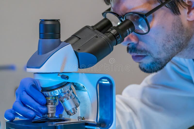 Scientist In Laboratory Is Looking Inside Microscope. Microbiology And ...