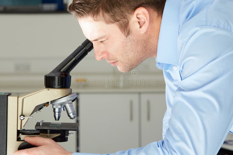 Scientist Looking through Microscope in Laboratory Stock Photo - Image ...