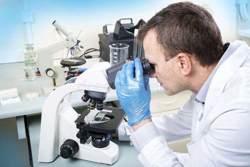 Scientist Looking through Microscope in Laboratory Stock Image - Image ...