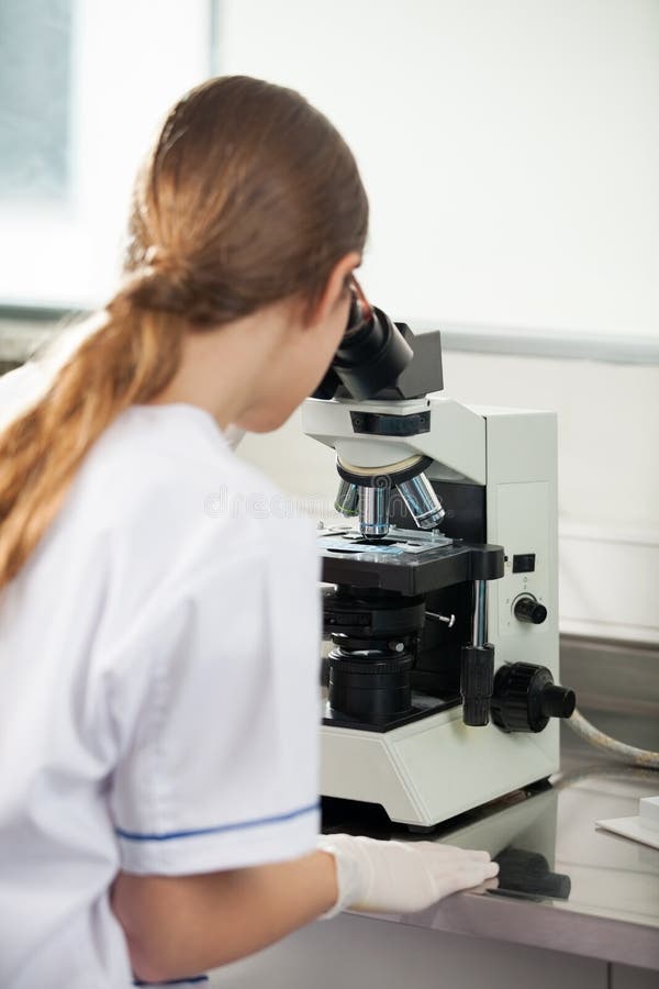 Scientist Looking through Microscope Stock Image - Image of clinic ...