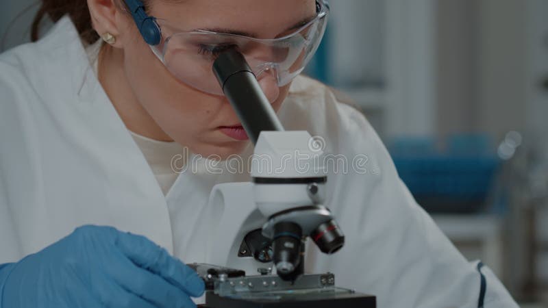 Scientist Looking through Microscopic Lens To Work on Experiment Stock ...