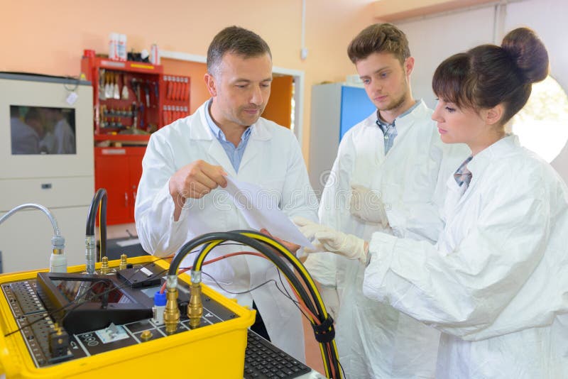 Scientist Looking at Readings from Machine Stock Photo - Image of ...