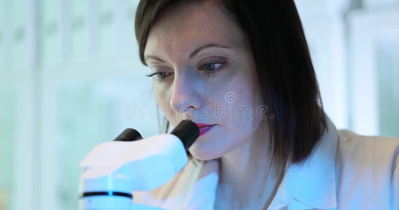 Scientist Looks through Microscope in Research Laboratory. Science and ...