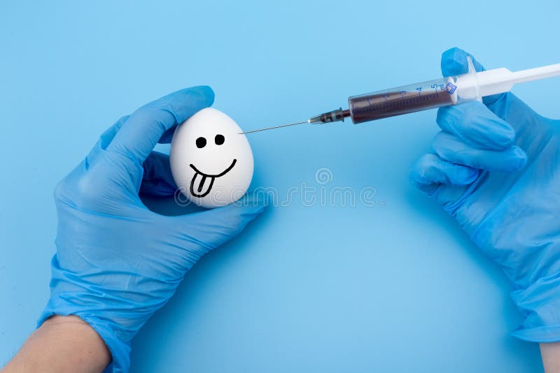 The Scientist Makes an Injection with a Syringe into the Egg Stock ...