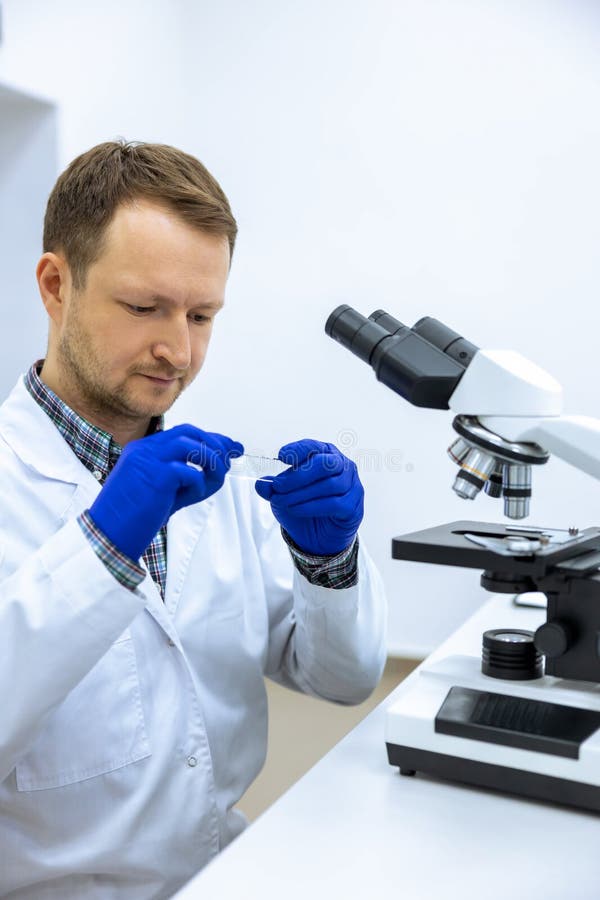 Scientist Man Doing Microbiology Experiment, Looking Sample Under ...