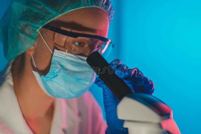 Scientist in Medical Mask Working with Microscope Stock Photo - Image ...