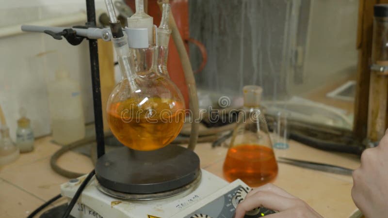 Scientist Mixing Liquids in Flasks in a Research Lab. Special Equipment ...