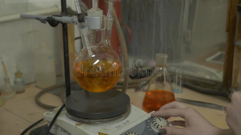 Scientist Mixing Liquids in Flasks in a Research Lab. Special Equipment ...