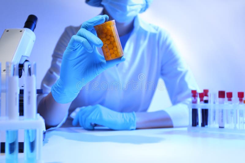 Scientist with Pills at Table in Laboratory, Closeup Stock Image ...