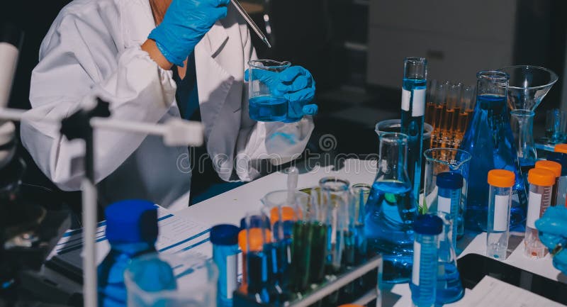 Scientist Pipetting Medical Samples into Microplate in Laboratory Stock ...