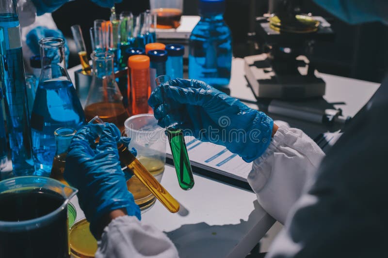 Scientist Pipetting Medical Samples into Microplate in Laboratory Stock ...