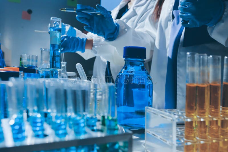 Scientist Pipetting Medical Samples into Microplate in Laboratory Stock ...