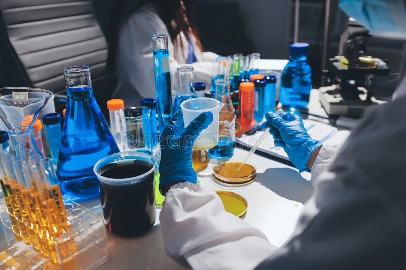 Scientist Pipetting Medical Samples into Microplate in Laboratory Stock ...